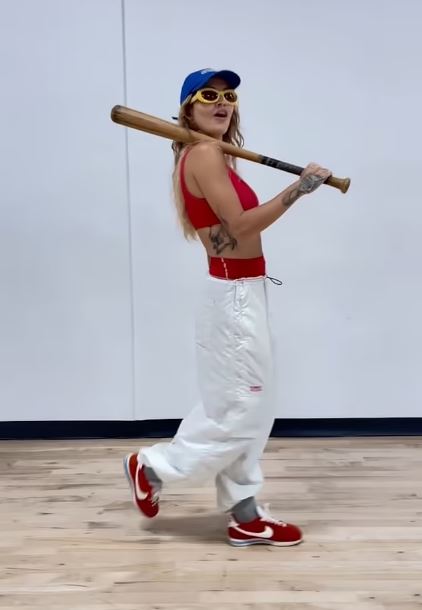 Rita Ora shows off her toned stomach in a red top as she teases new single